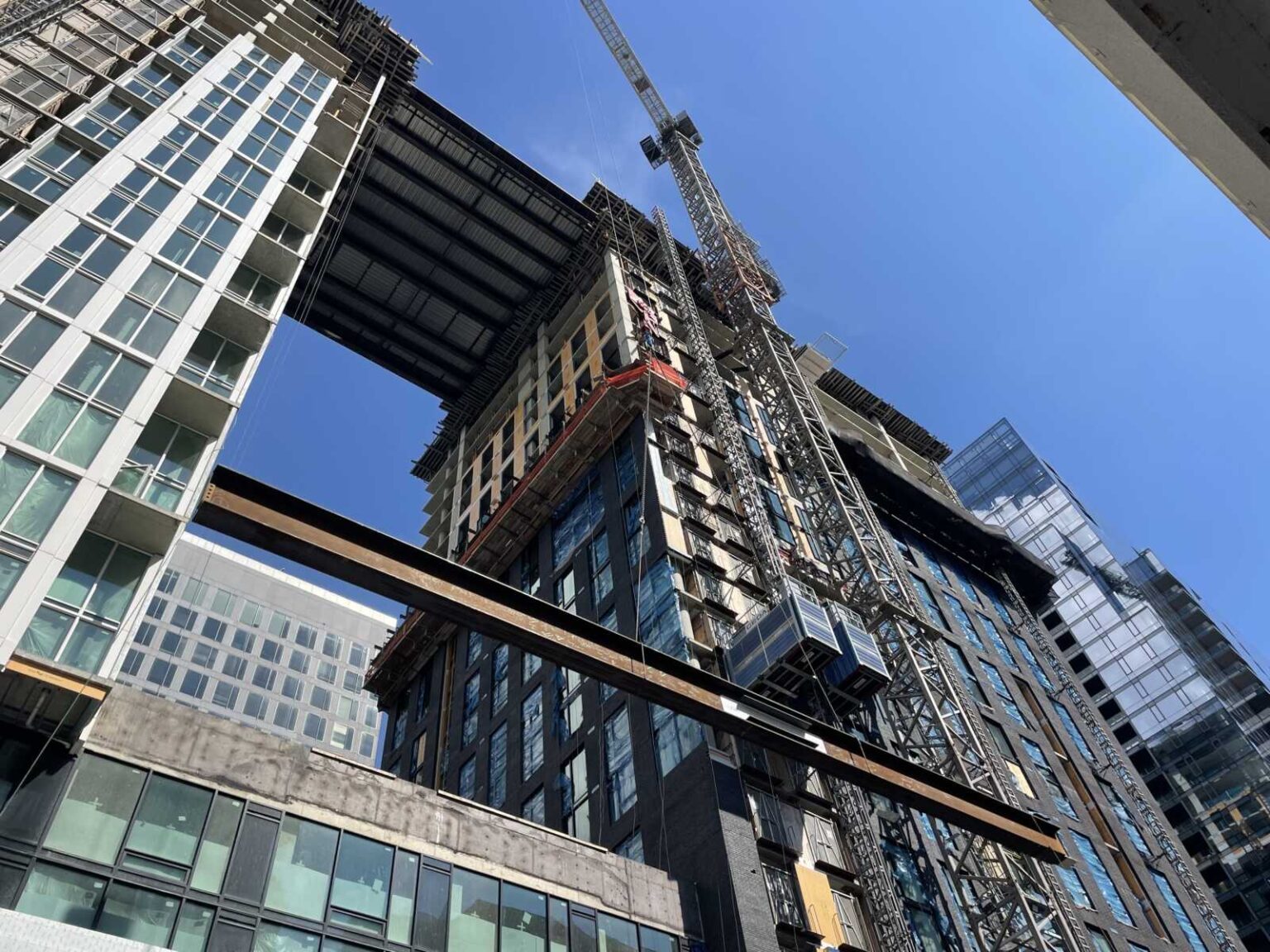 New 422-unit pair of apartment towers receives its final beam in ...